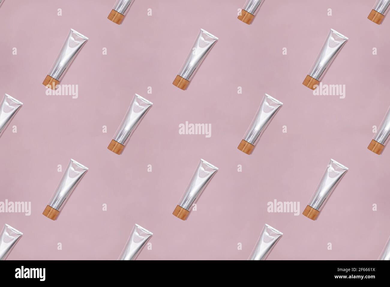 Toothpaste in metal container on pink background Stock Photo - Alamy