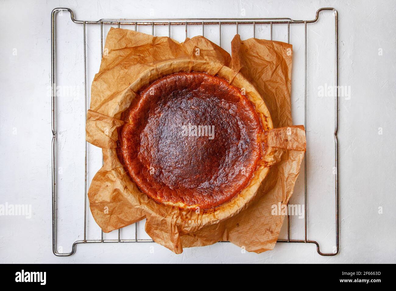 Homemade Basque burnt cheesecake immediately after baking on a rack ...