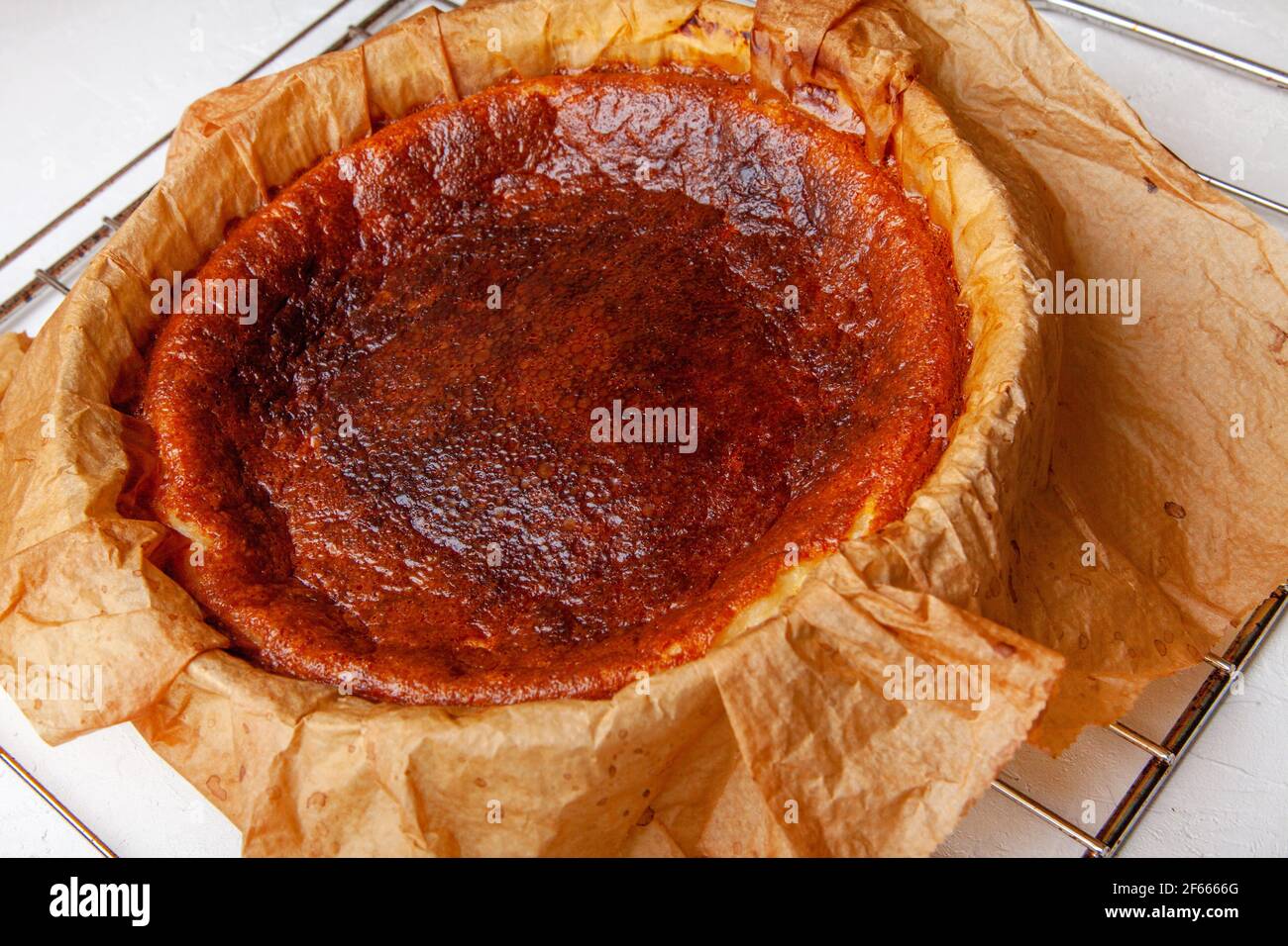 Homemade Basque burnt cheesecake immediately after baking on a rack ...