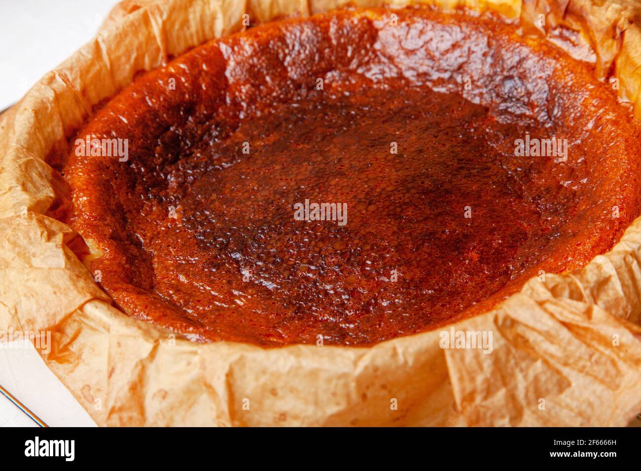 Homemade Basque burnt cheesecake immediately after baking on a rack ...