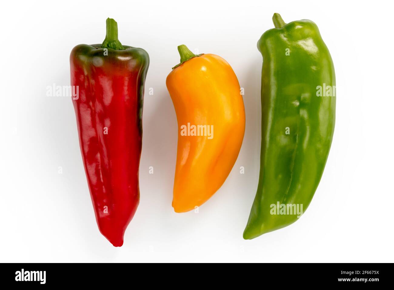 three pointy peppers, red, yellow and green peppers isolated on white ...