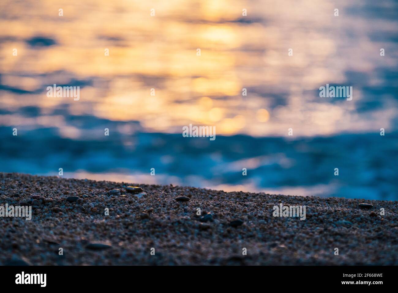 Selective focus on the sand on the beach during sunset at sea Stock ...