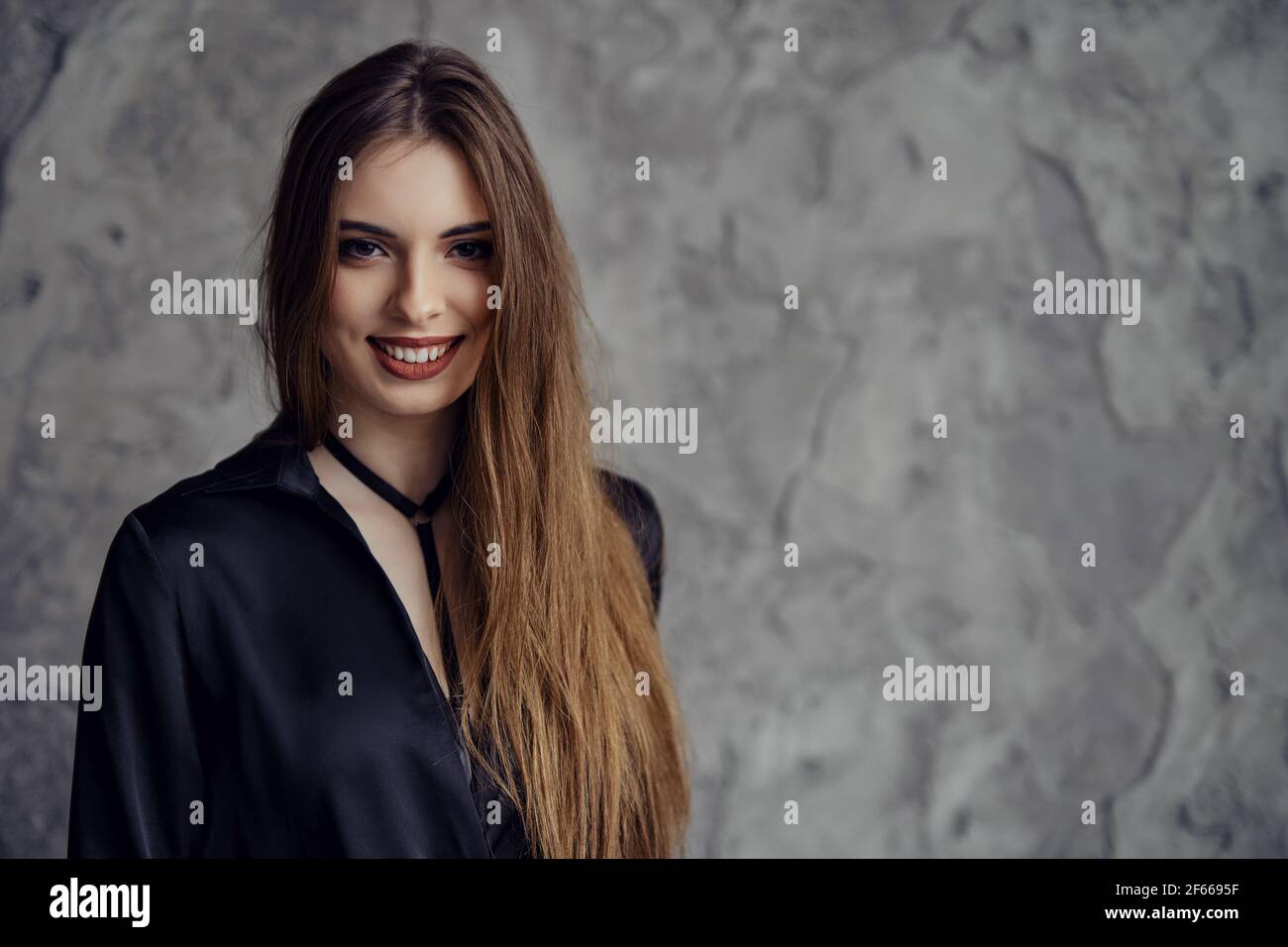 Young smiling woman looking straight forward. Photo with place for text ...