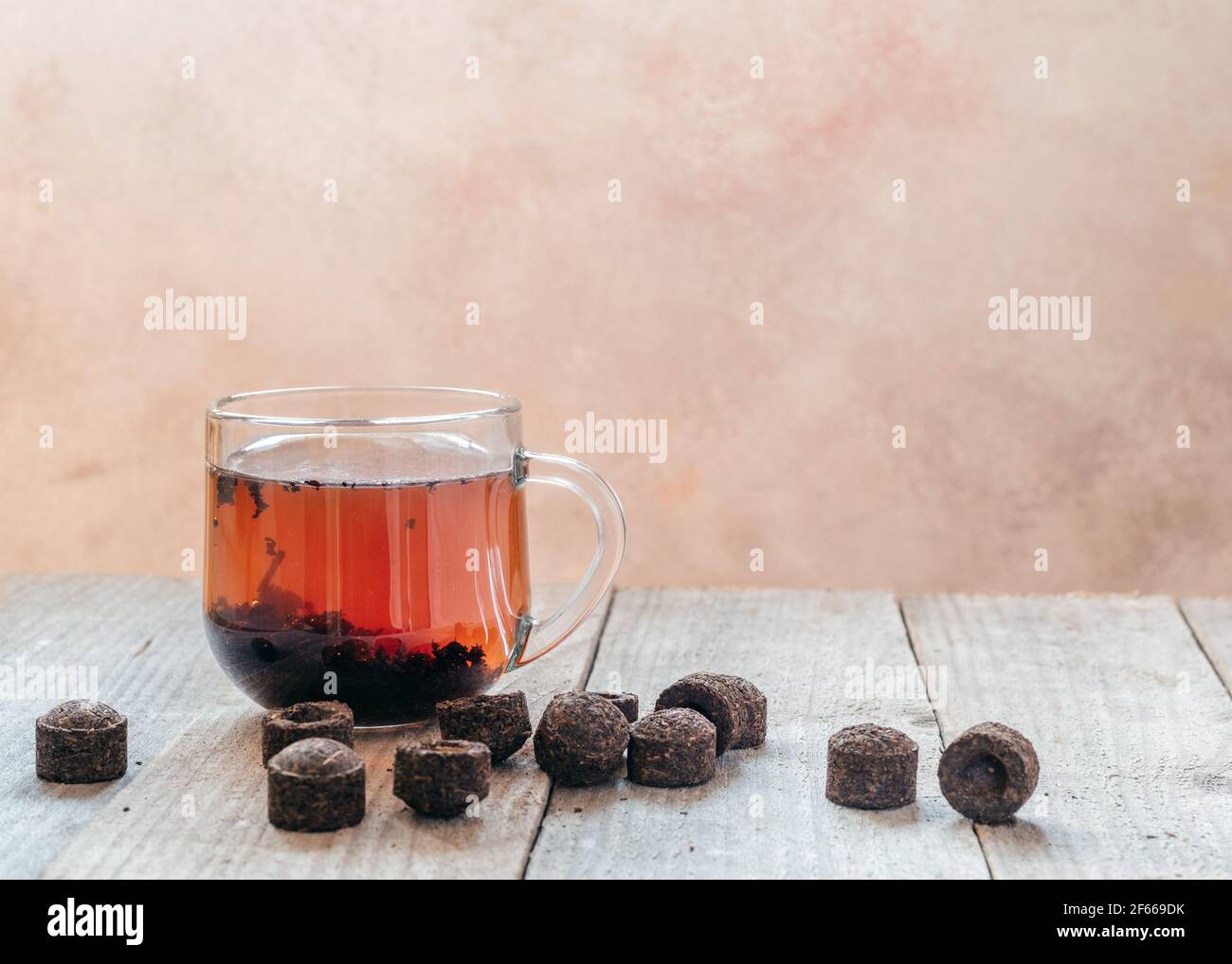 A cup of traditional Chinese puer tea with aged puerh tea bricks Stock ...