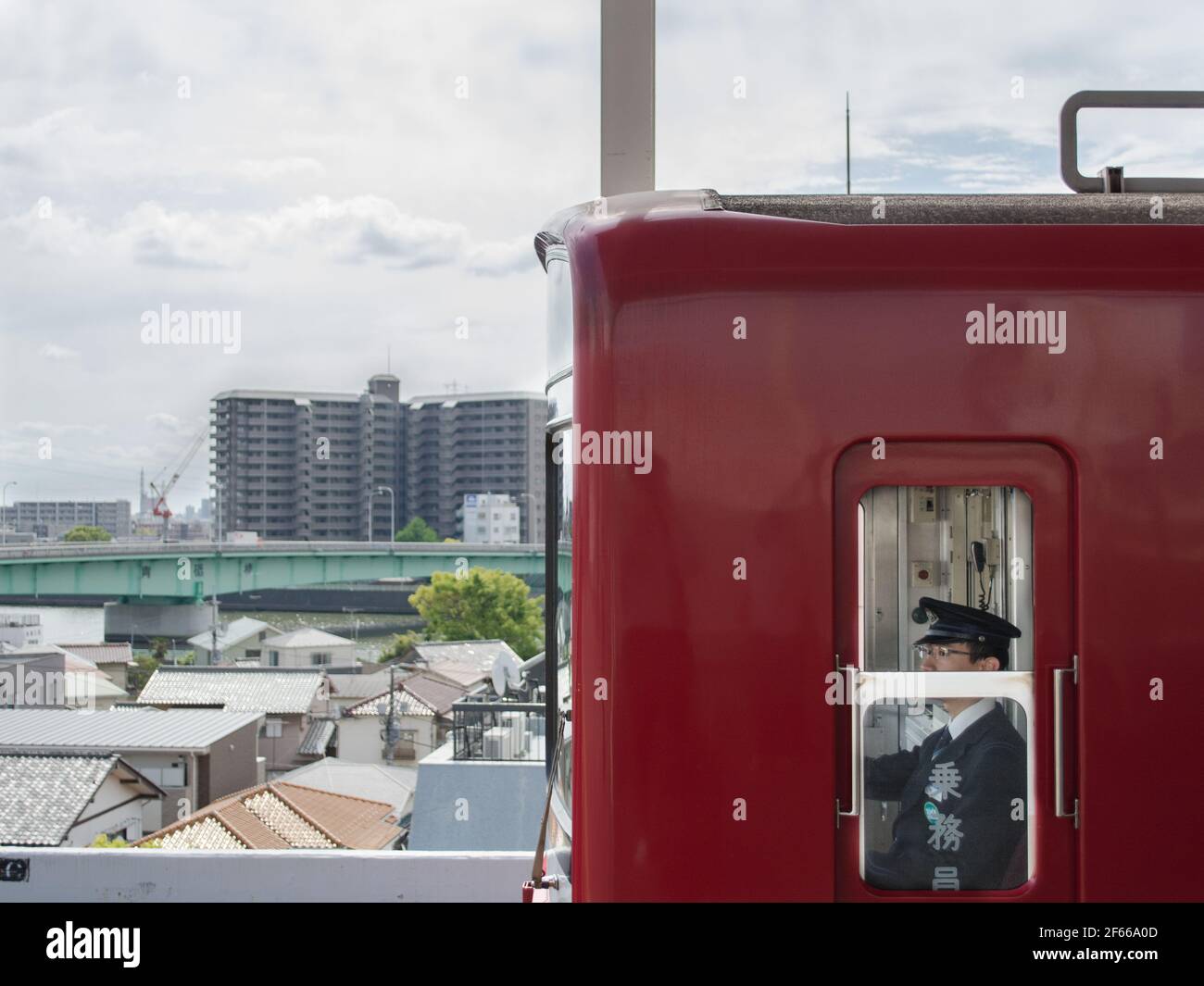 Tokyo, Japan - A train driver departing the station. Residential ...