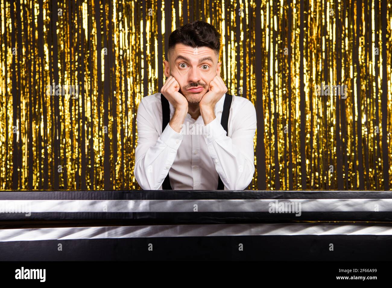 Photo of young handsome man unhappy sad hands touch cheeks bored party ...