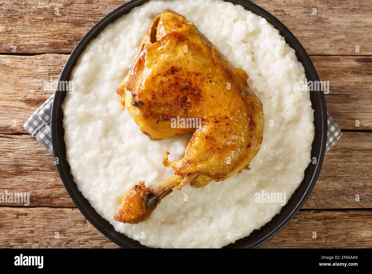 Saudi Arabia dish Saleeg of creamy rice served with chicken close-up in ...