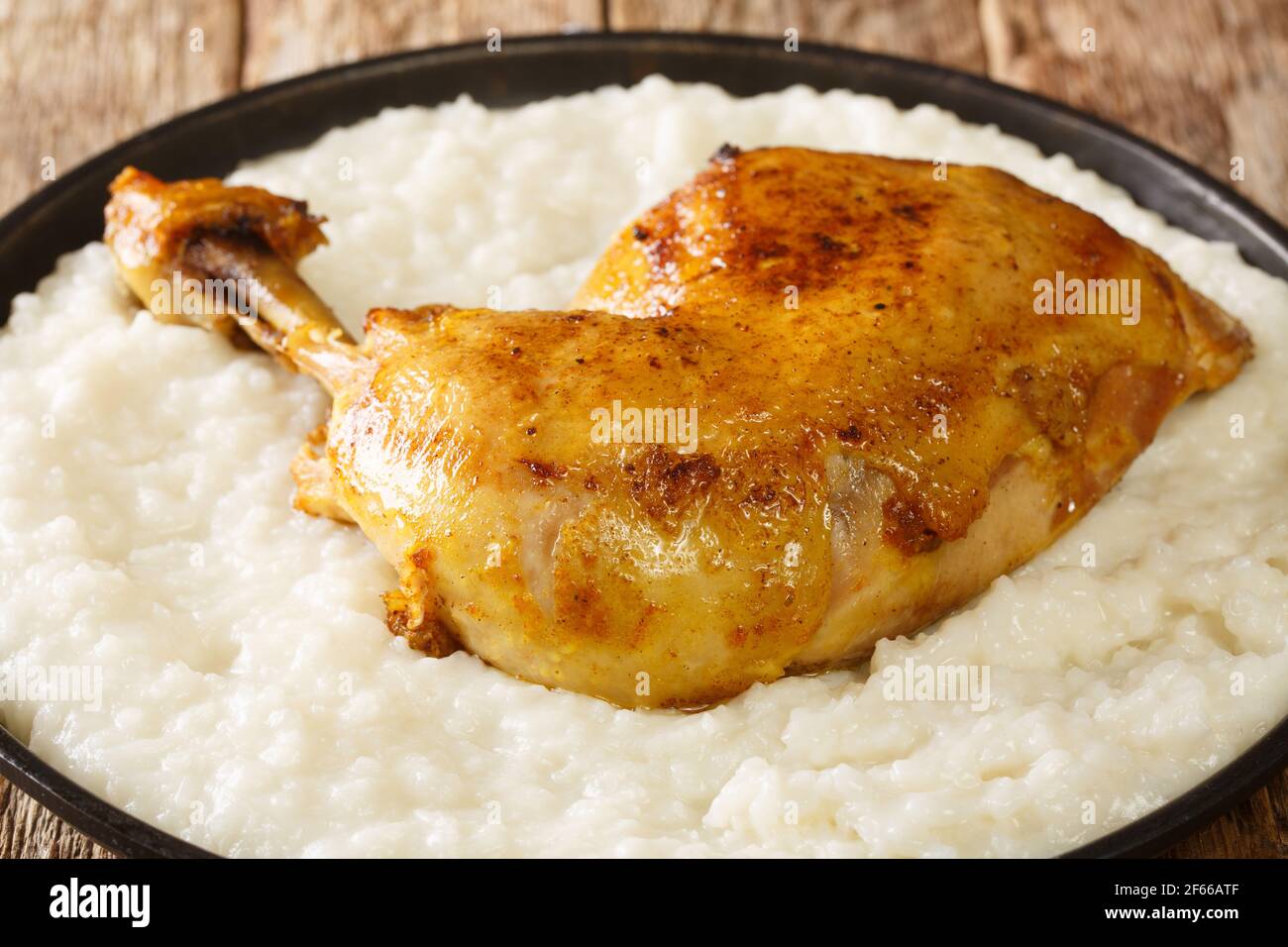 Saudi Arabia dish Saleeg of creamy rice served with chicken close-up in ...