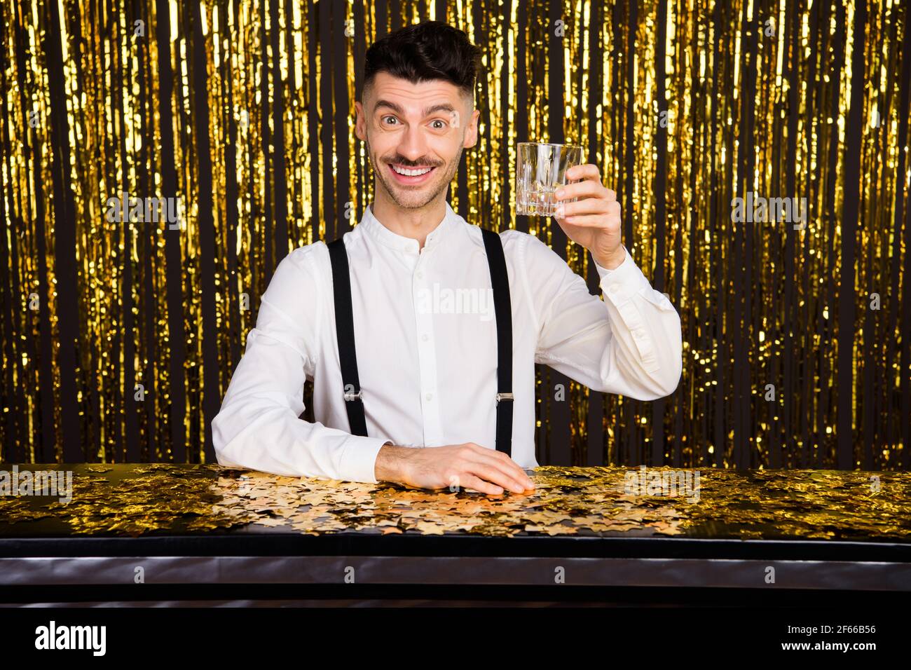 Photo of young cheerful man happy positive smile drink alcohol cheers ...