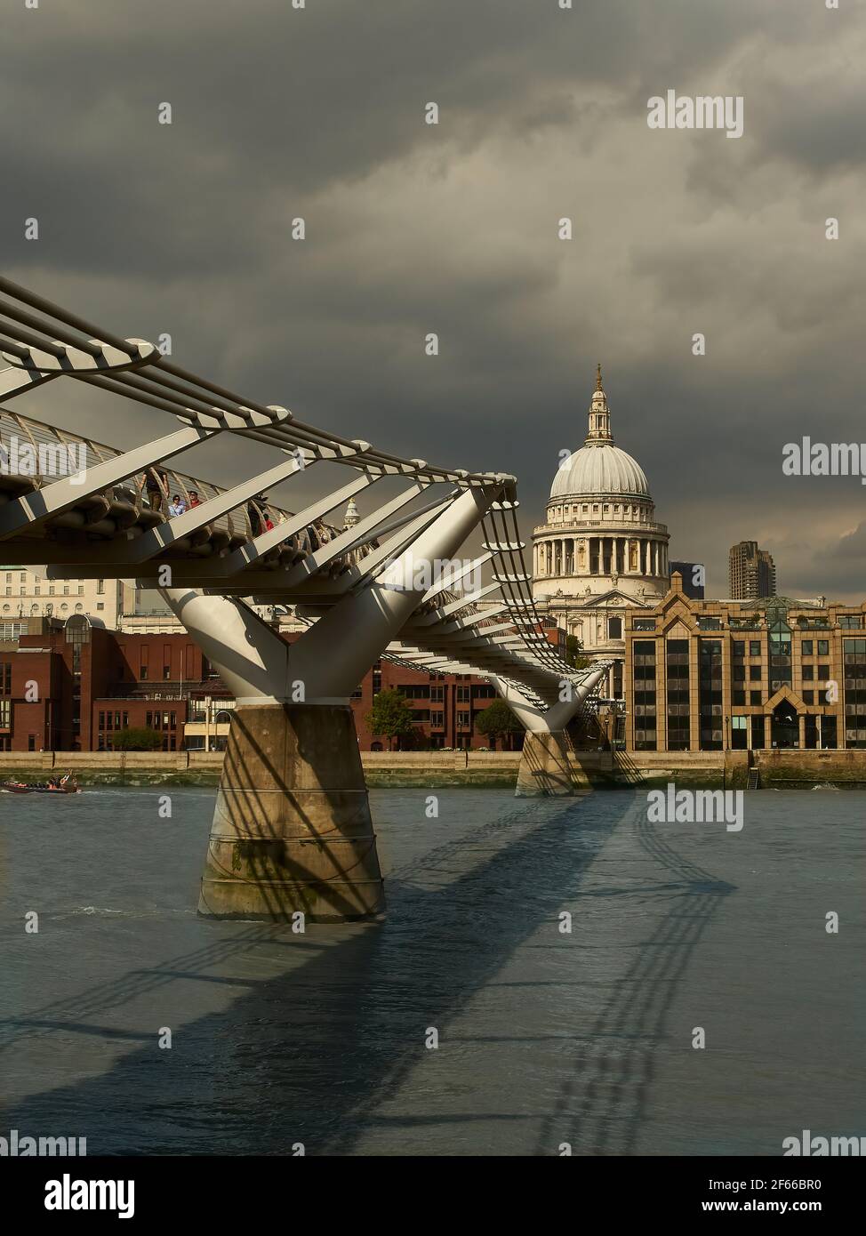 St. Paul's Cathedral against a moody sky, looking along the Millennium ...