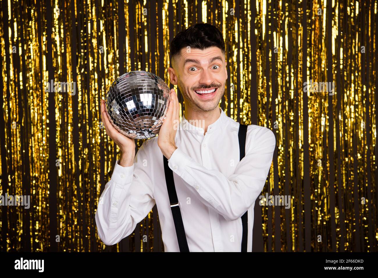 Photo of young cheerful man happy positive smile hold disco ball party ...