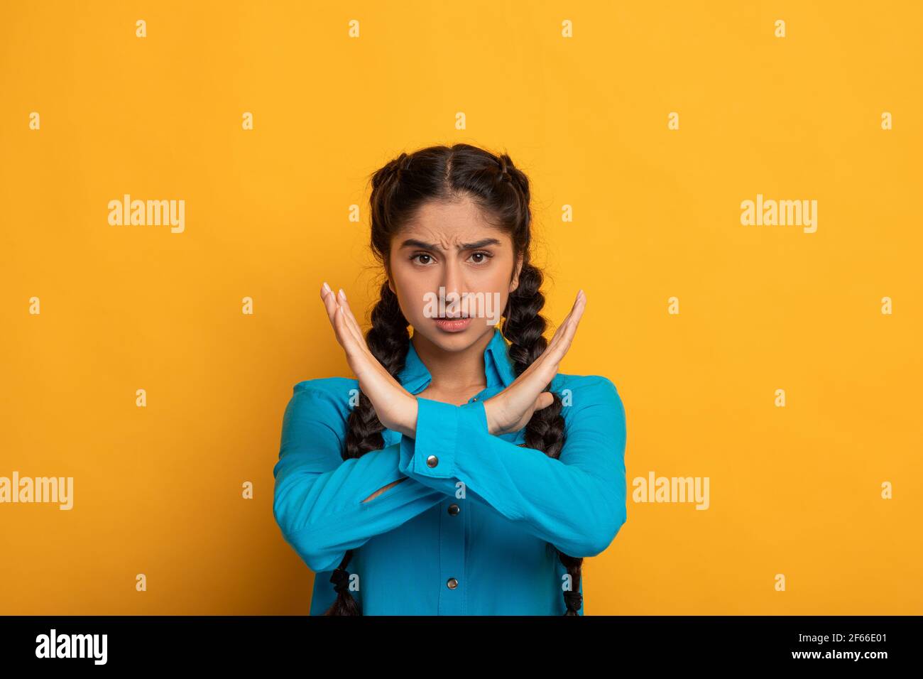 Angry indian woman crossing arms showing stop gesture Stock Photo - Alamy