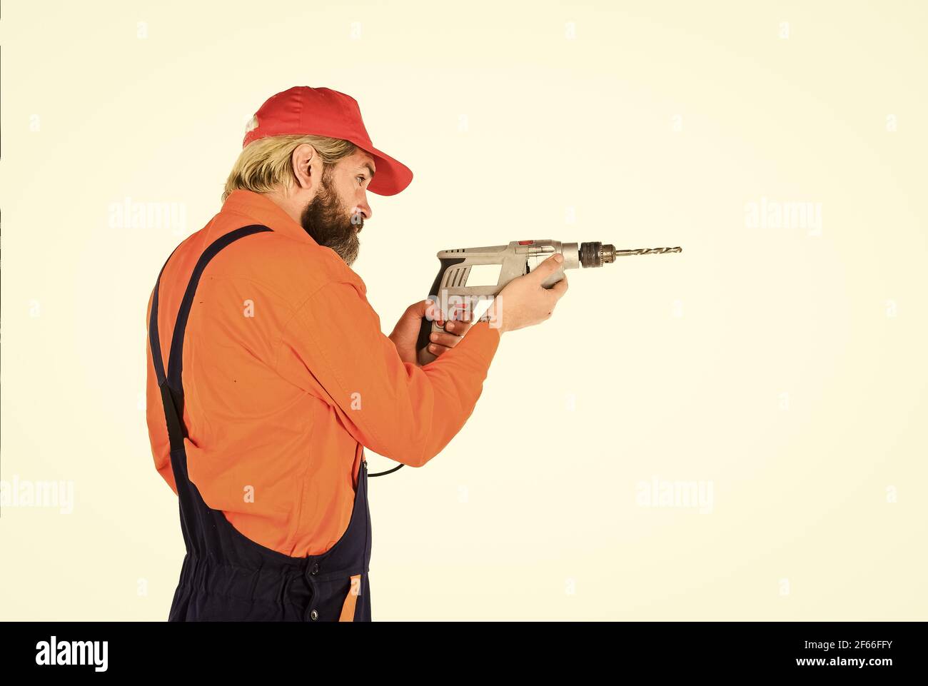 For drilling solid wall you need masonry bit. Man in cap with drills ...