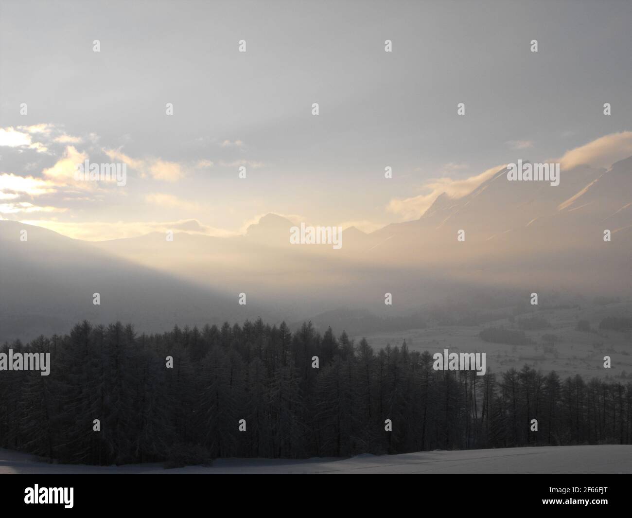 View of snow covered mountains overlooking forrest high above the ...