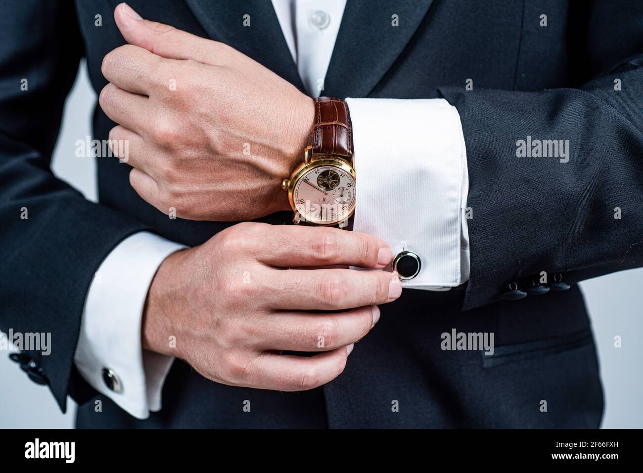 Modern horology. Wrist watch worn with formal suit. Portable timepiece ...