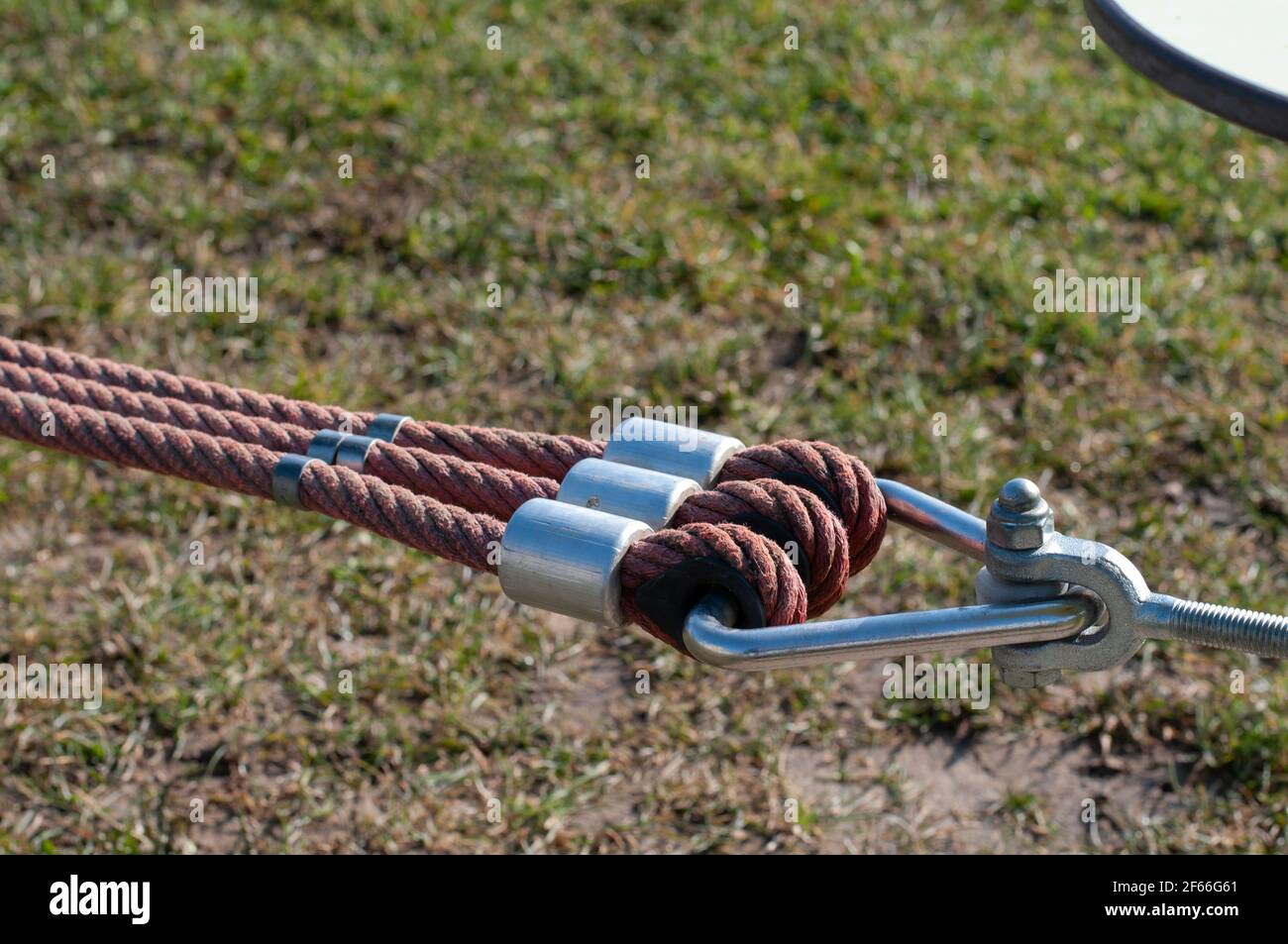 a balancing rope at a playground consisting of three braided ropes ...