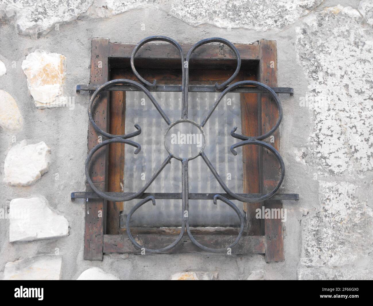 Iron flower window art on old house in south of France Stock Photo - Alamy