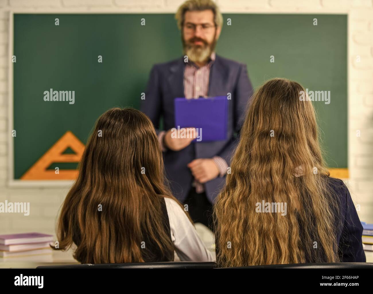 Elementary Pupil With Teacher In Classroom. Discussion group of ...