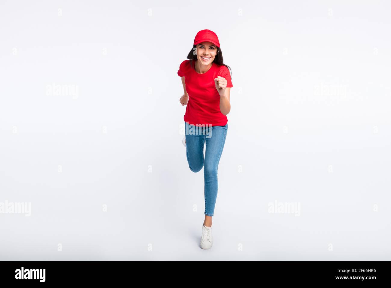 Full size photo of young beautiful smiling delivery girl running fast ...