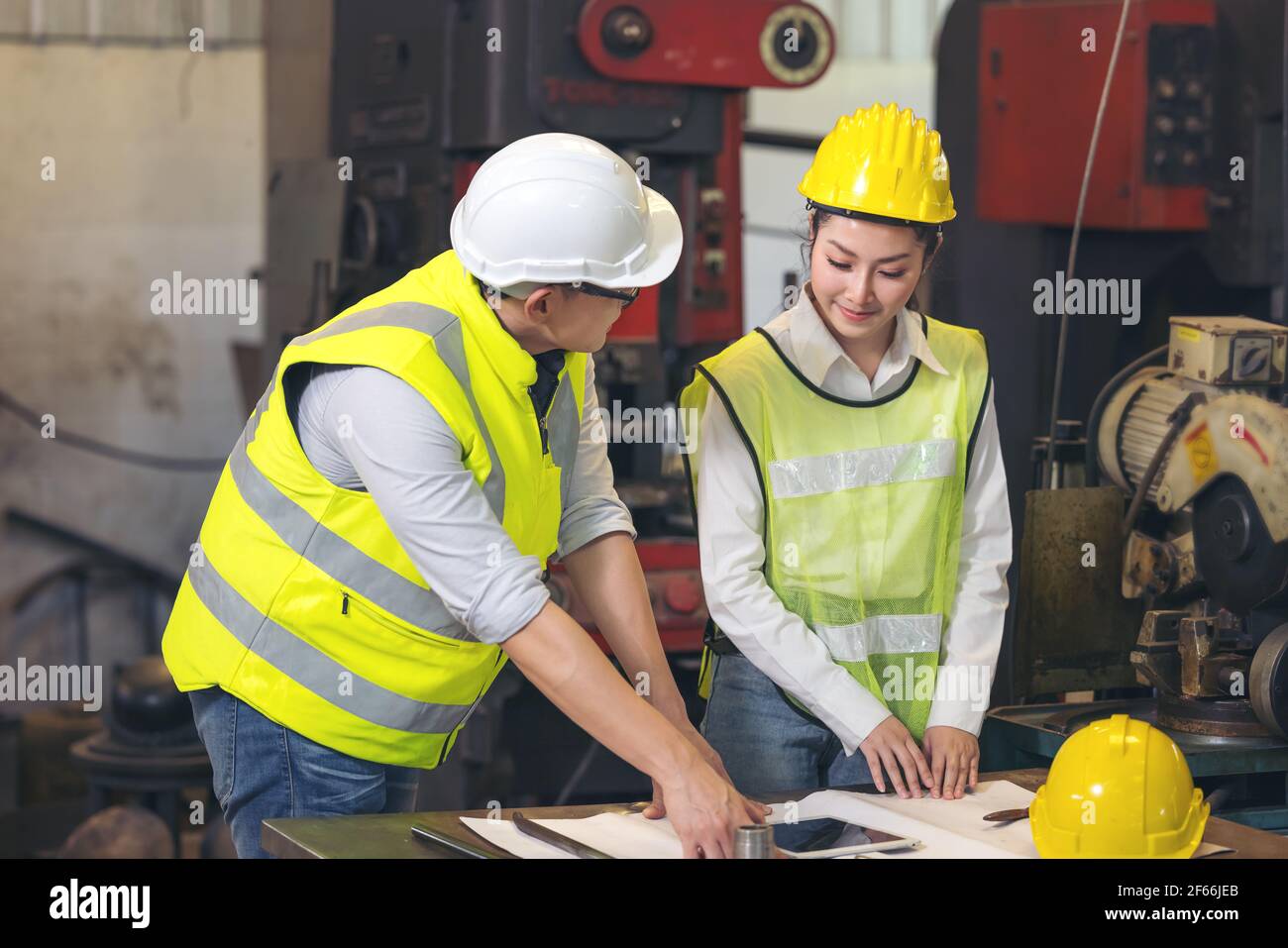 Contractor and engineer with blueprints discuss at a modern ...