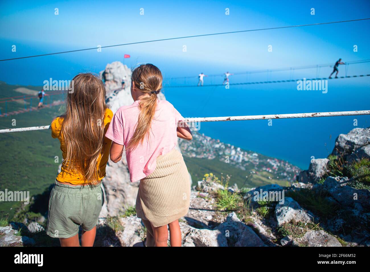 Girls crossing the chasm on the rope bridge Stock Photo - Alamy