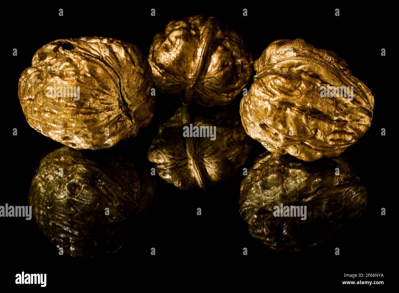 Golden walnuts on black background, studio shot Stock Photo - Alamy