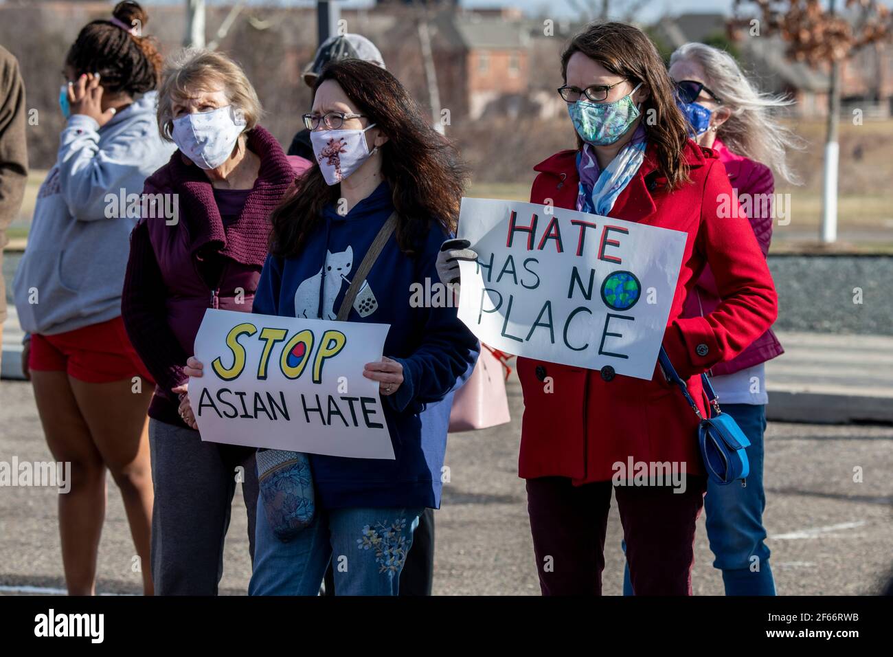 Maple Grove, Minnesota. March 25, 2021. Masked protesters at a stop ...