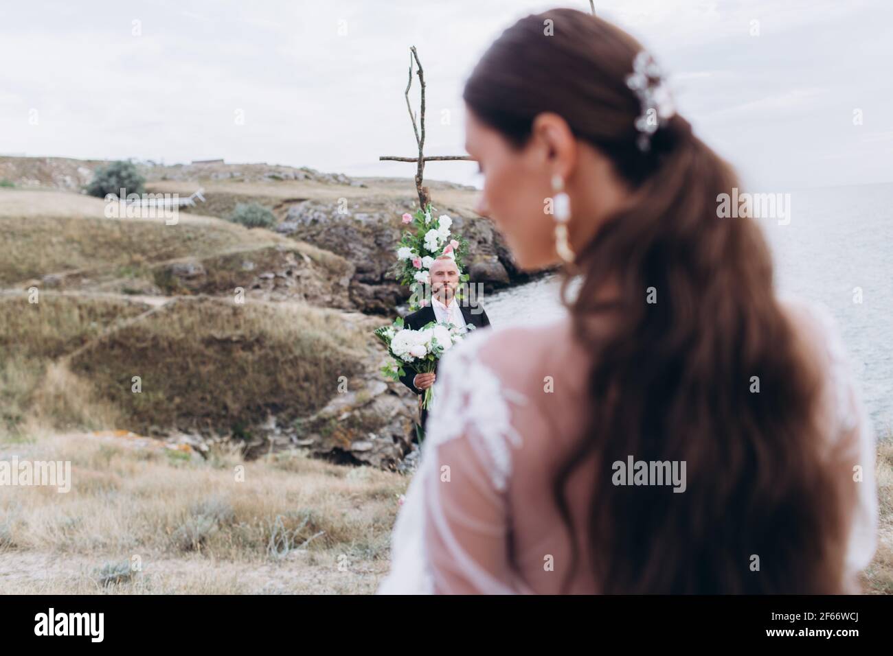 Exit ceremony of couples near the sea and rocks Stock Photo - Alamy