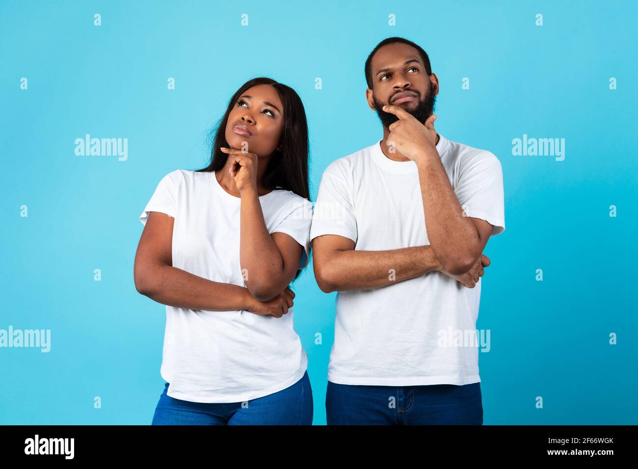 African American man and woman thinking on blue background Stock Photo ...