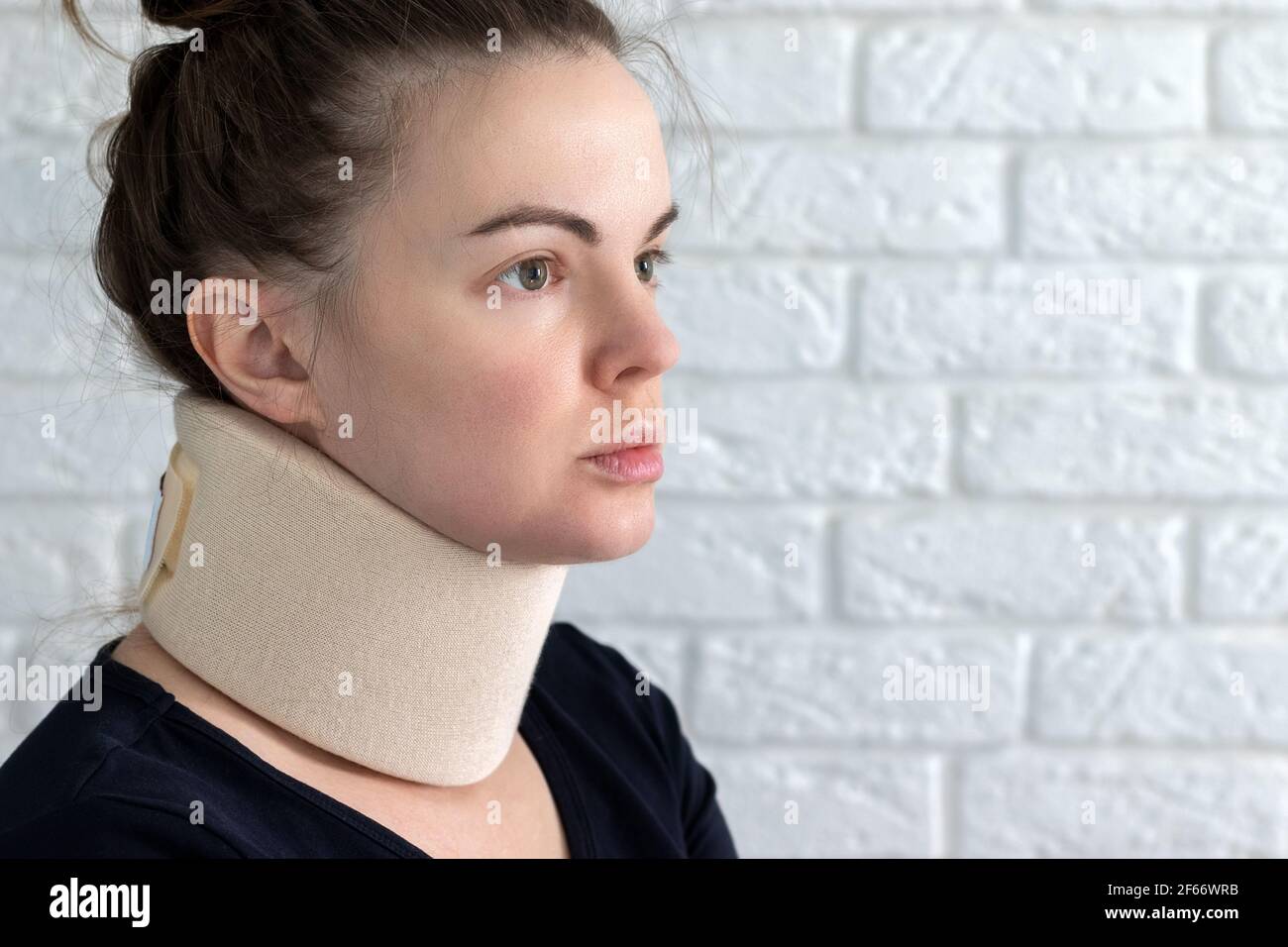 Woman with cervical surgical collar feeling pain in neck in home ...