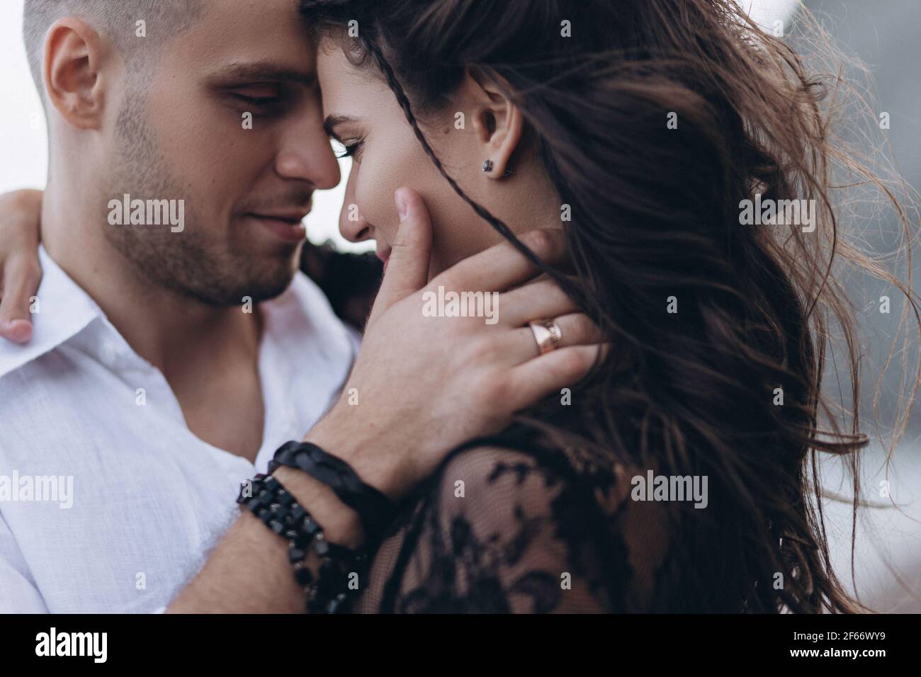 Wedding couple in love in boho style. Asymmetric bouquet of roses Stock ...