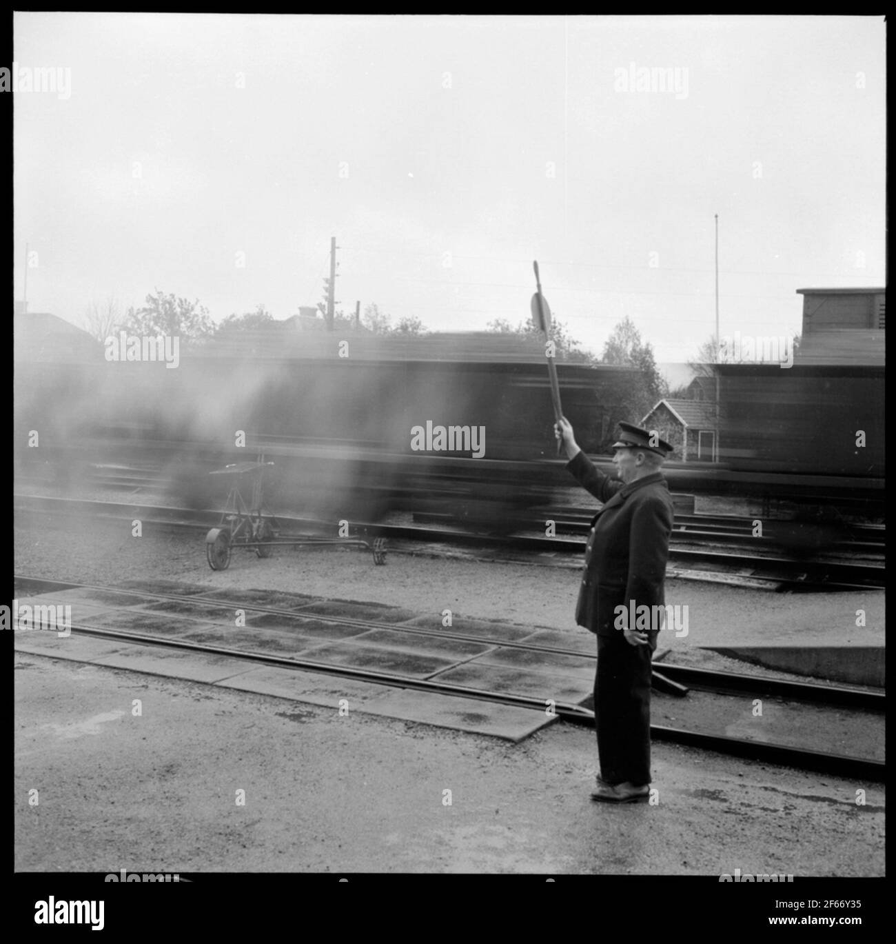 Railway officer provides signal Stock Photo - Alamy