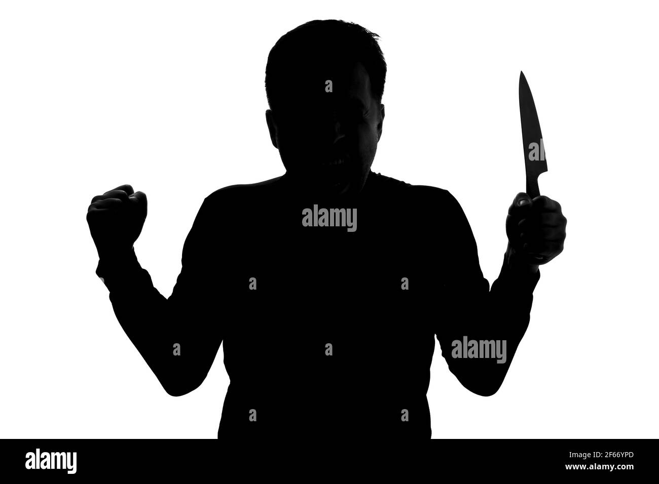 Silhouette of dangerous man with a knife in his hand being aggressive ...