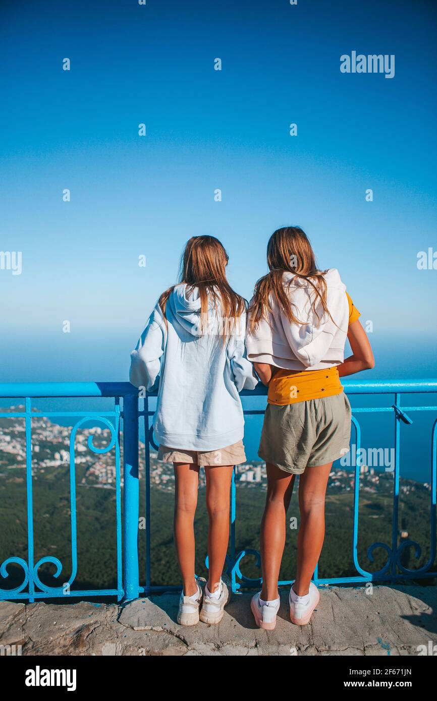 Girls crossing the chasm on the rope bridge Stock Photo - Alamy