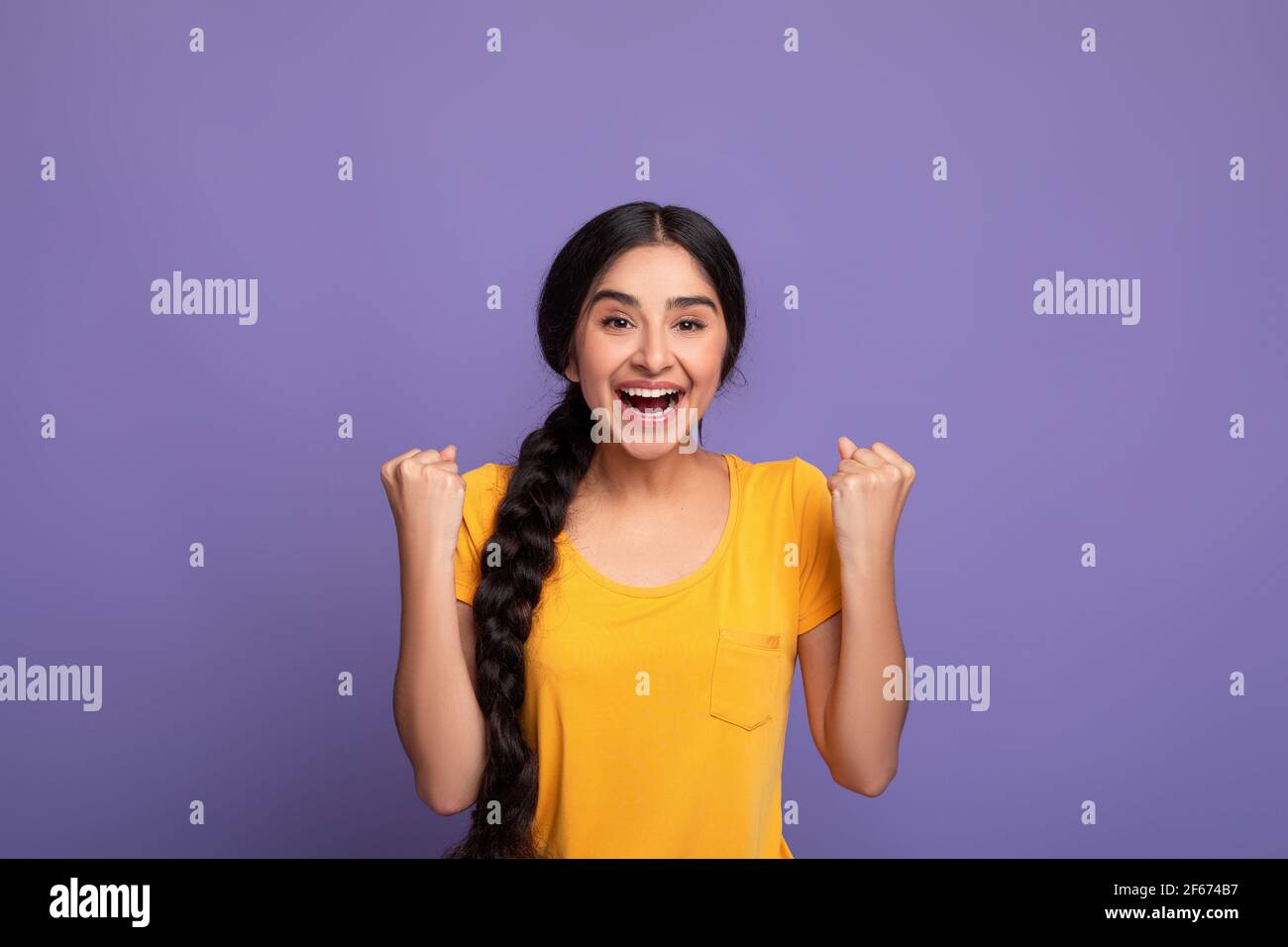 Yes. Portrait of emotional indian woman screaming with raised fists ...