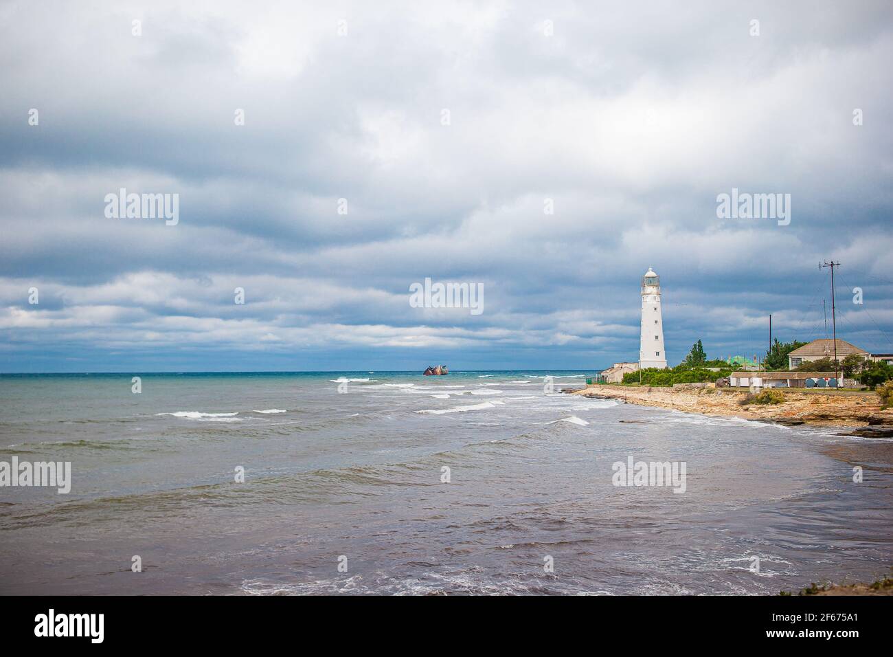 White lighthouse in a bay at sea Stock Photo - Alamy