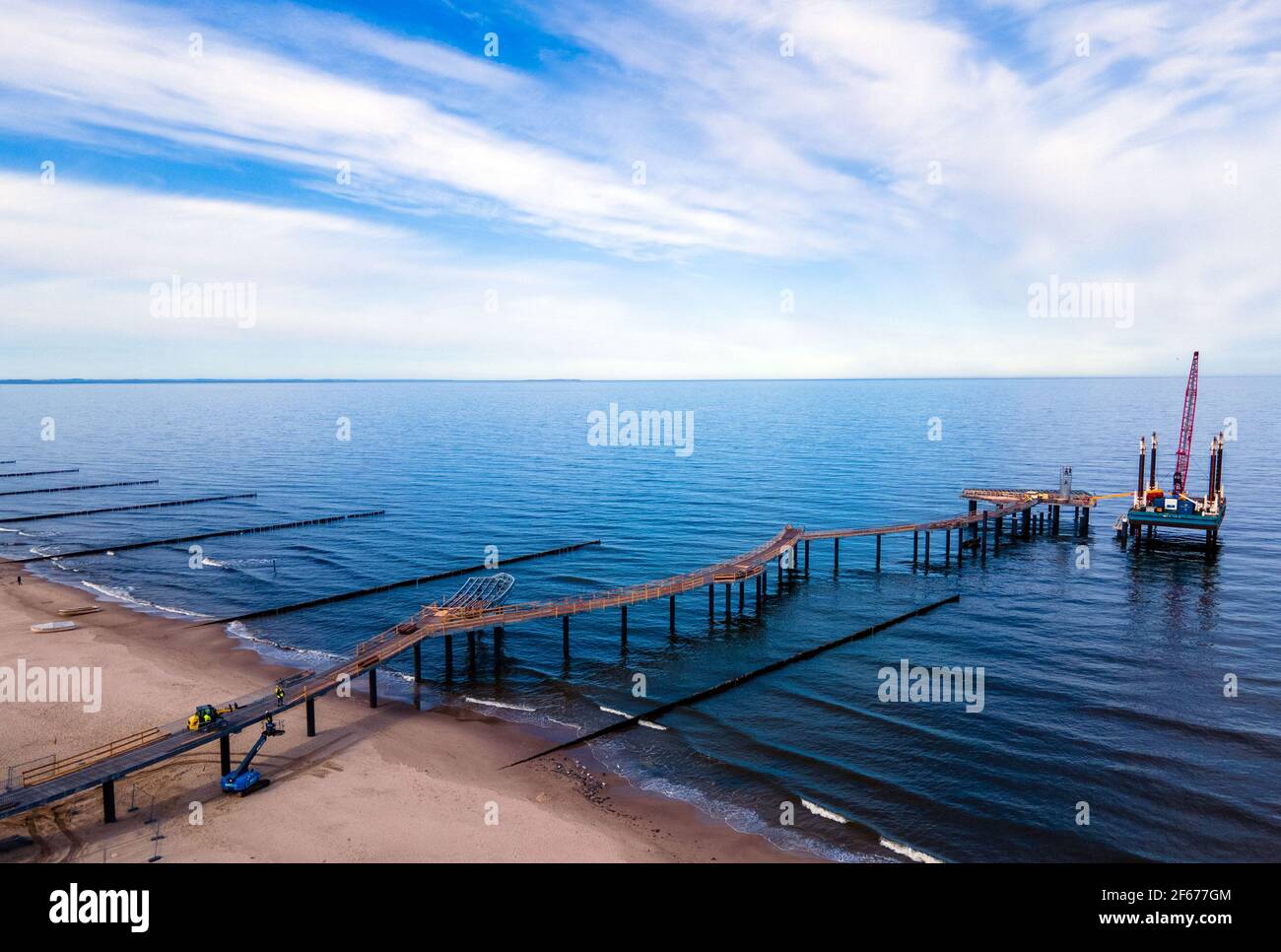 Koserow, Germany. 22nd Mar, 2021. A floating pontoon with a crane lies ...