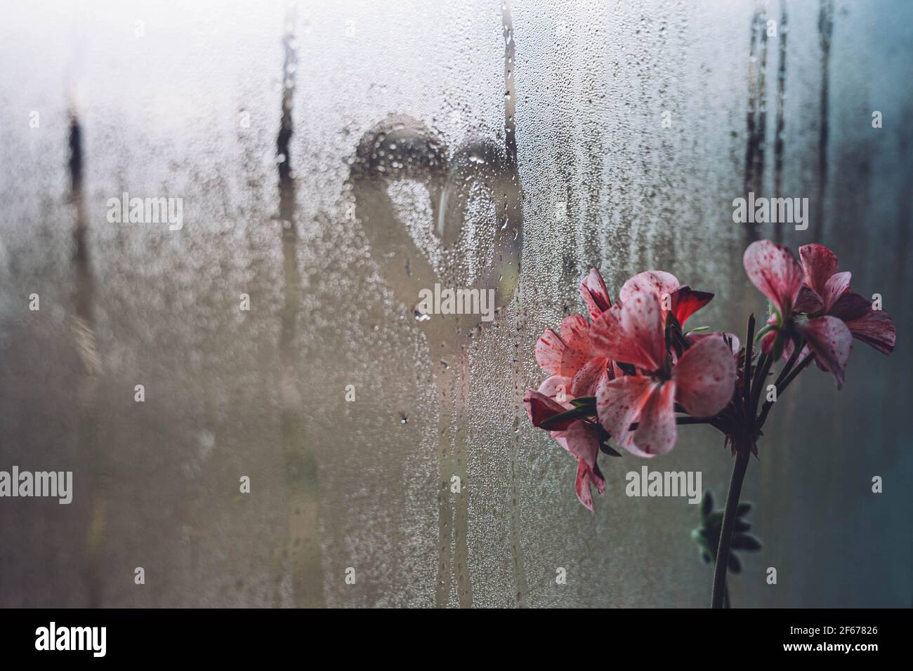 Heart shape drawn on glass window with water drops Stock Photo - Alamy