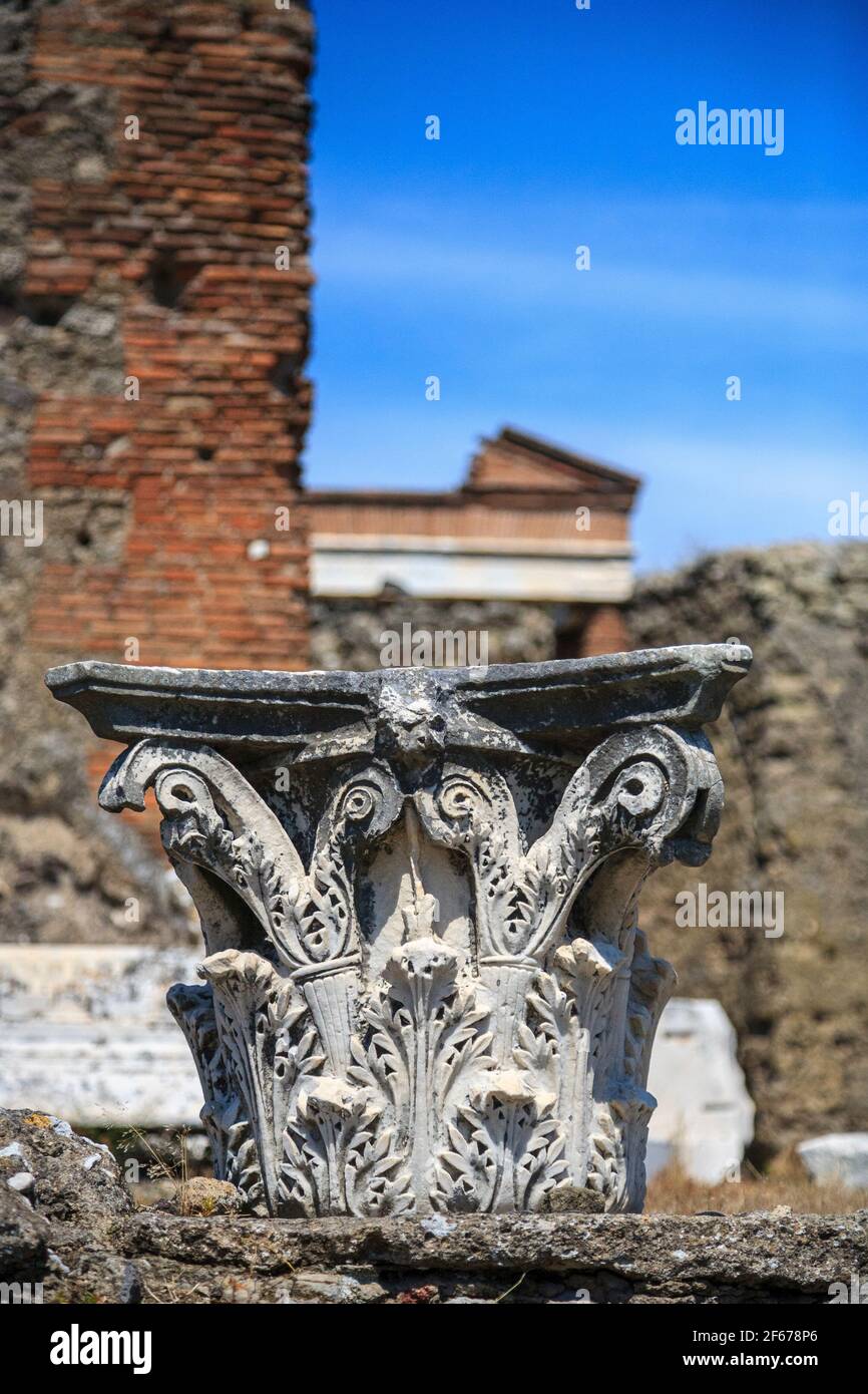 The capital of a fallen Roman column in the ruined city of Pompeii ...
