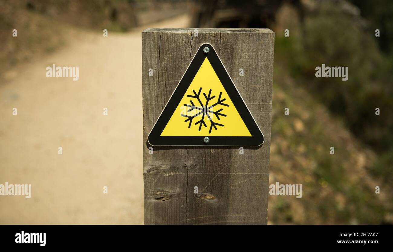 Ice hazard sign. Triangular yellow sign of low temperatures or ice ...