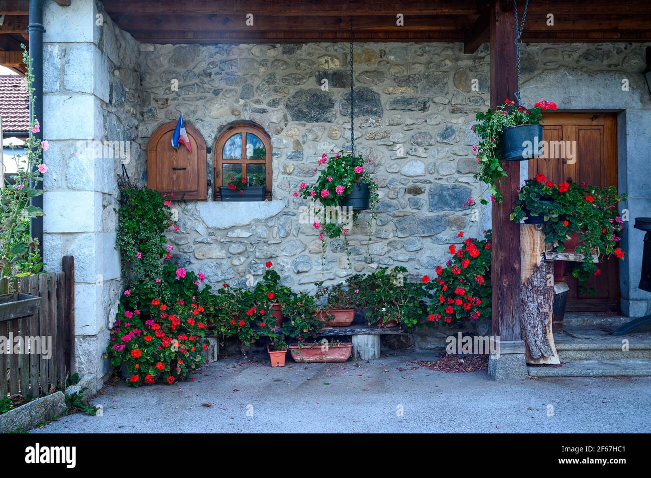 Red and pink floral decoration on roofed terrace in front of house ...