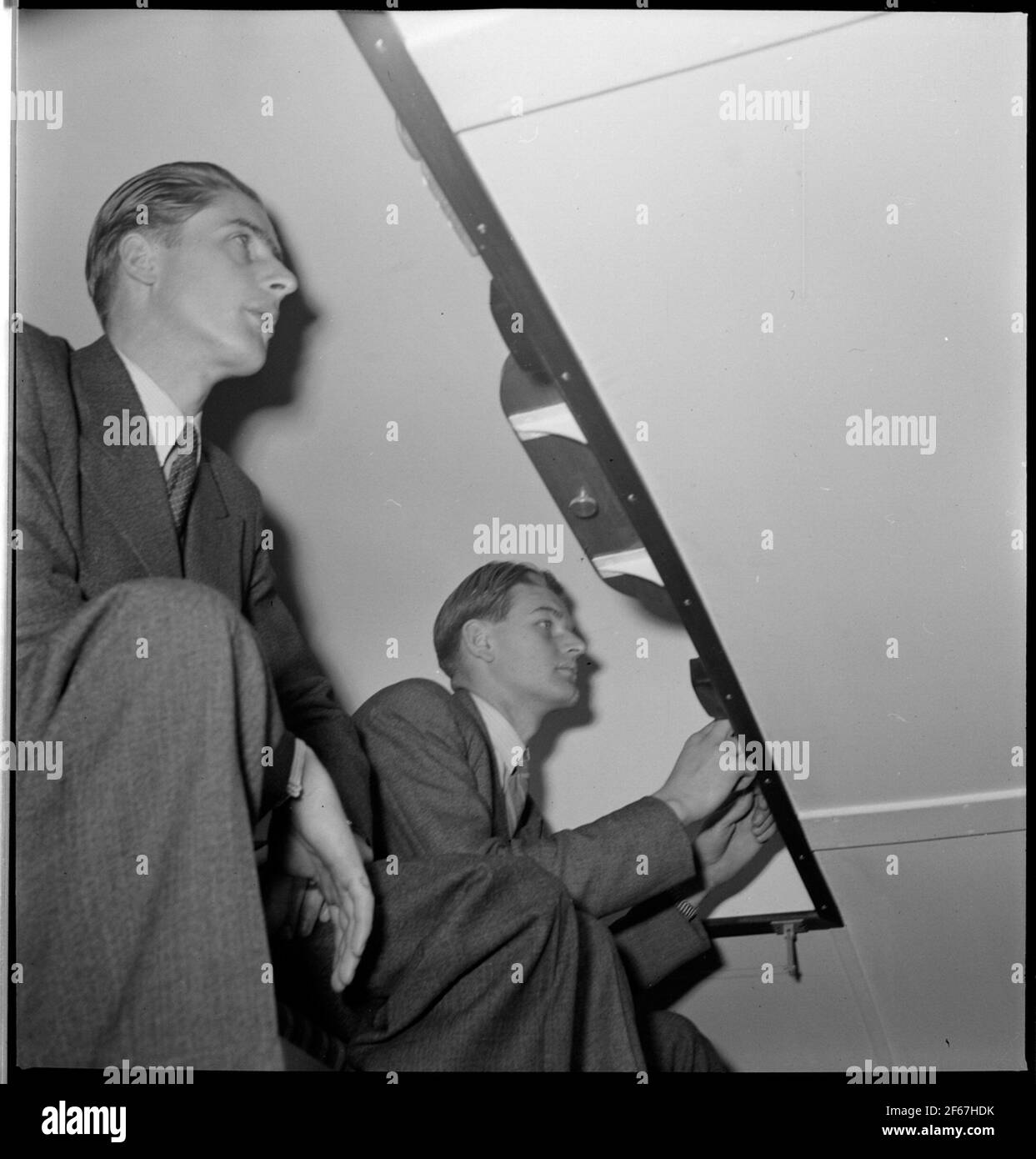 Two men in a measuring cart Stock Photo - Alamy