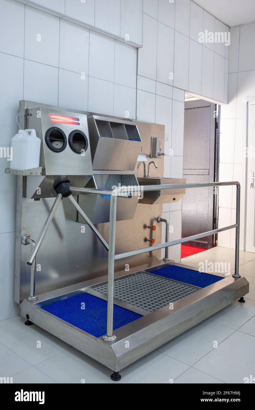Hand hygiene station with turnstile gate and sanitizer before entering ...