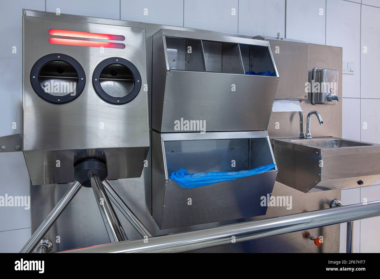 Hand hygiene station with turnstile gate and sanitizer before entering ...