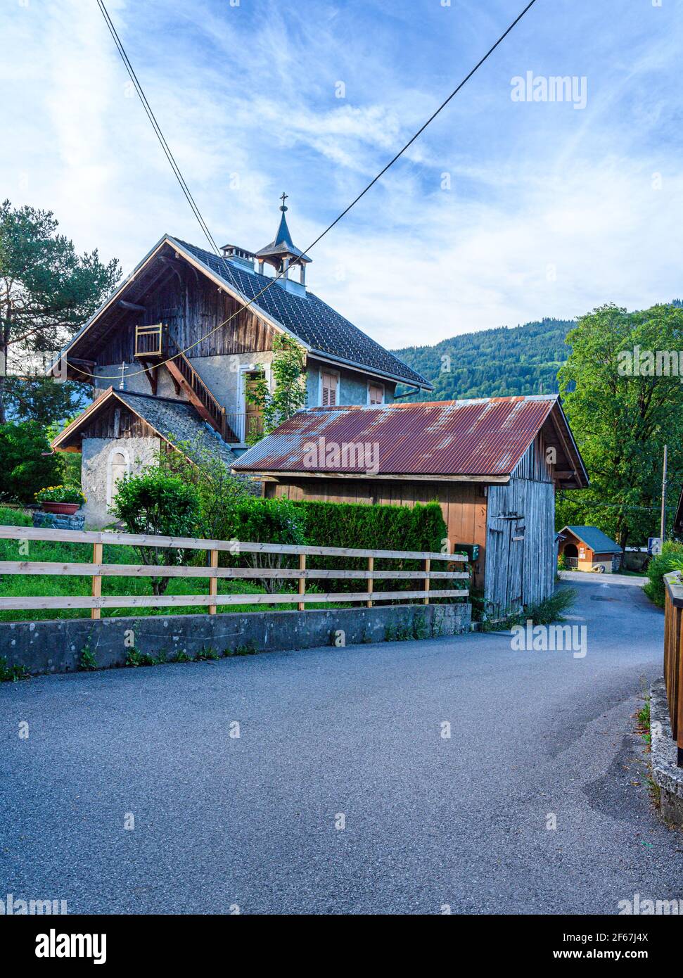 Rural building in mountain village. Two tier house with small turret ...
