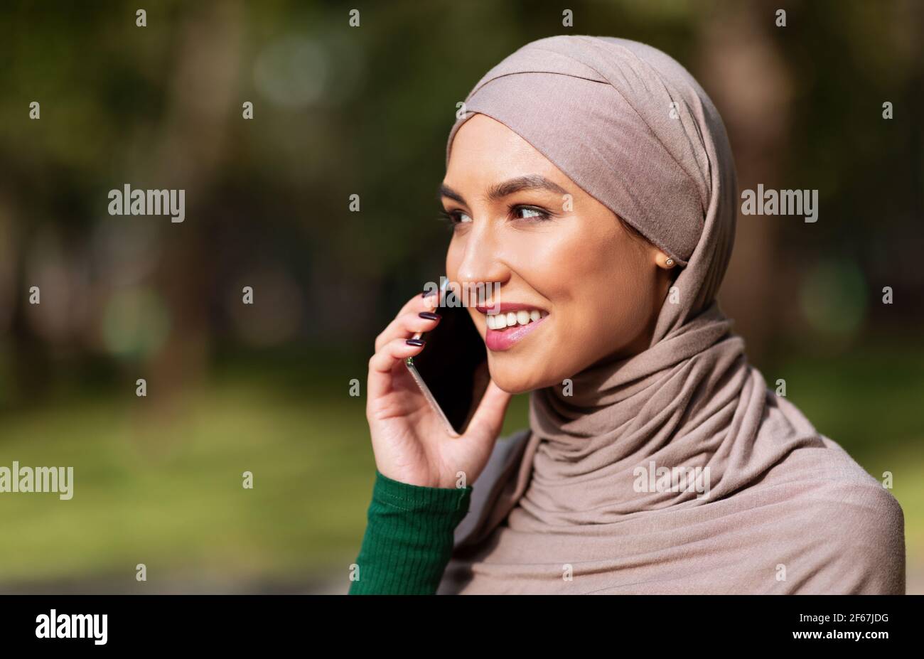 Happy Muslim Woman Talking On Phone Calling Friend Standing Outdoors ...