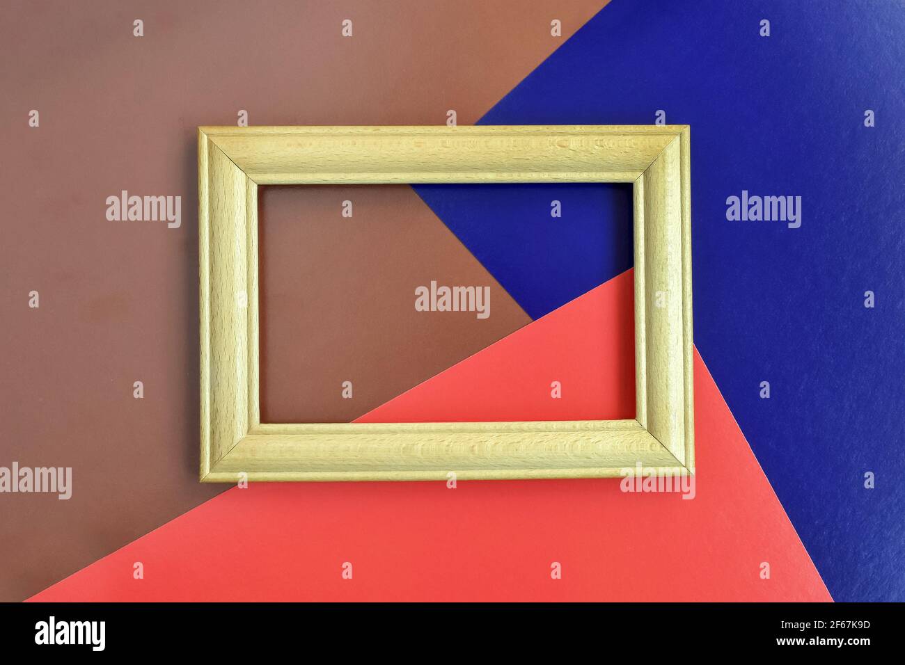 Empty wooden frame made of beech on multi-colored abstract paper ...