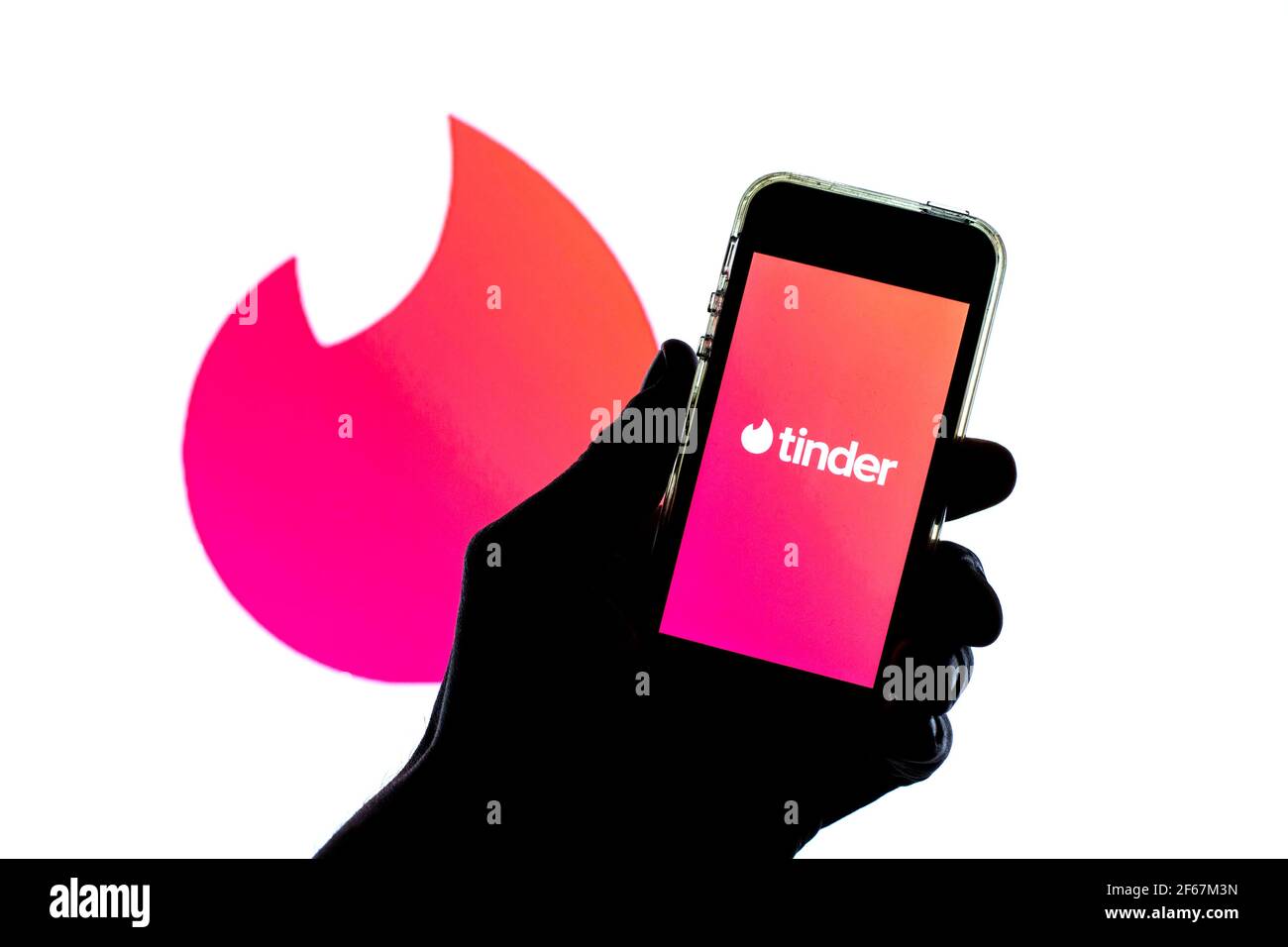 In this photo illustration, the Tinder app seen displayed on a ...