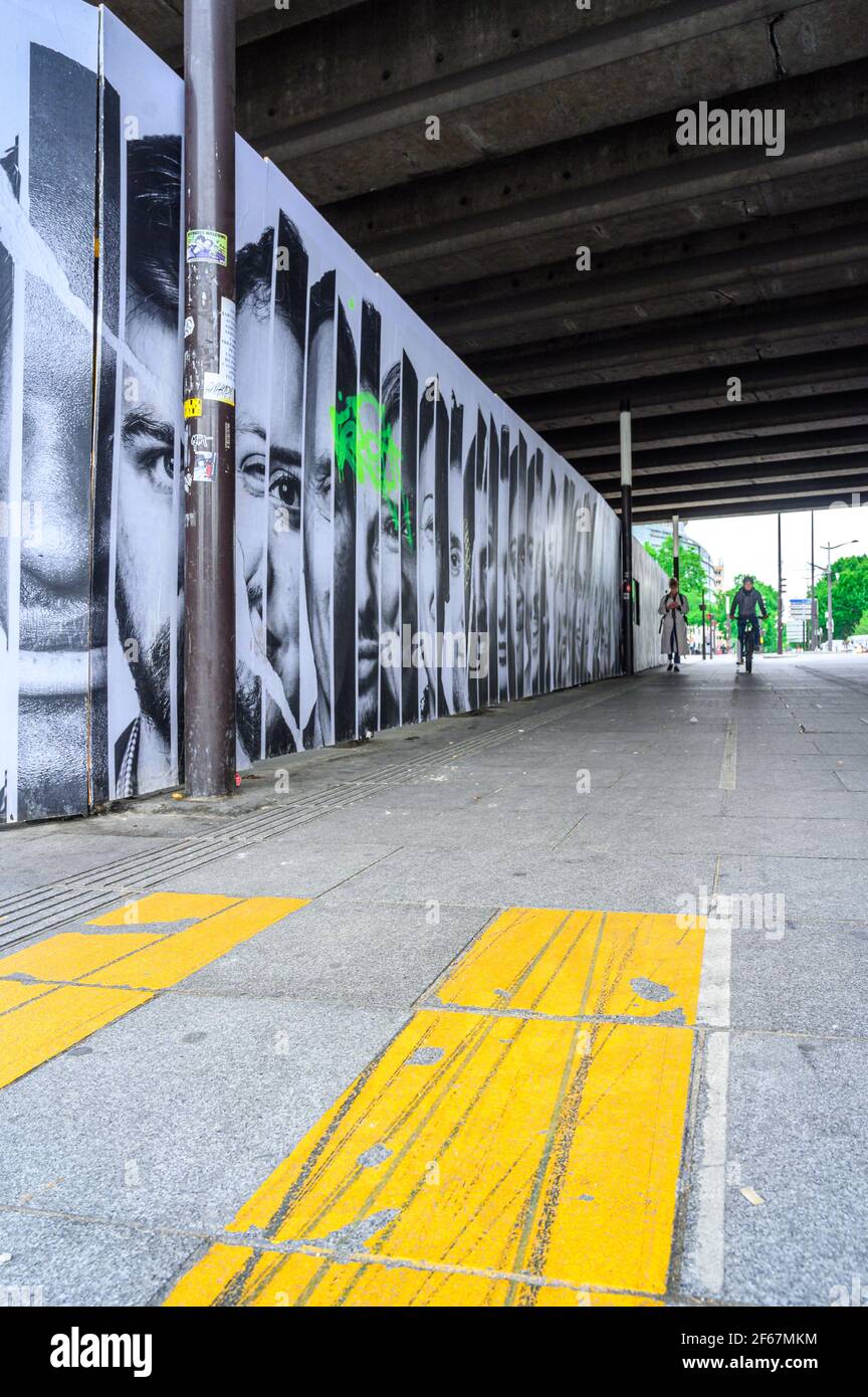 Low angle view of temporary protective wall with posters around ...