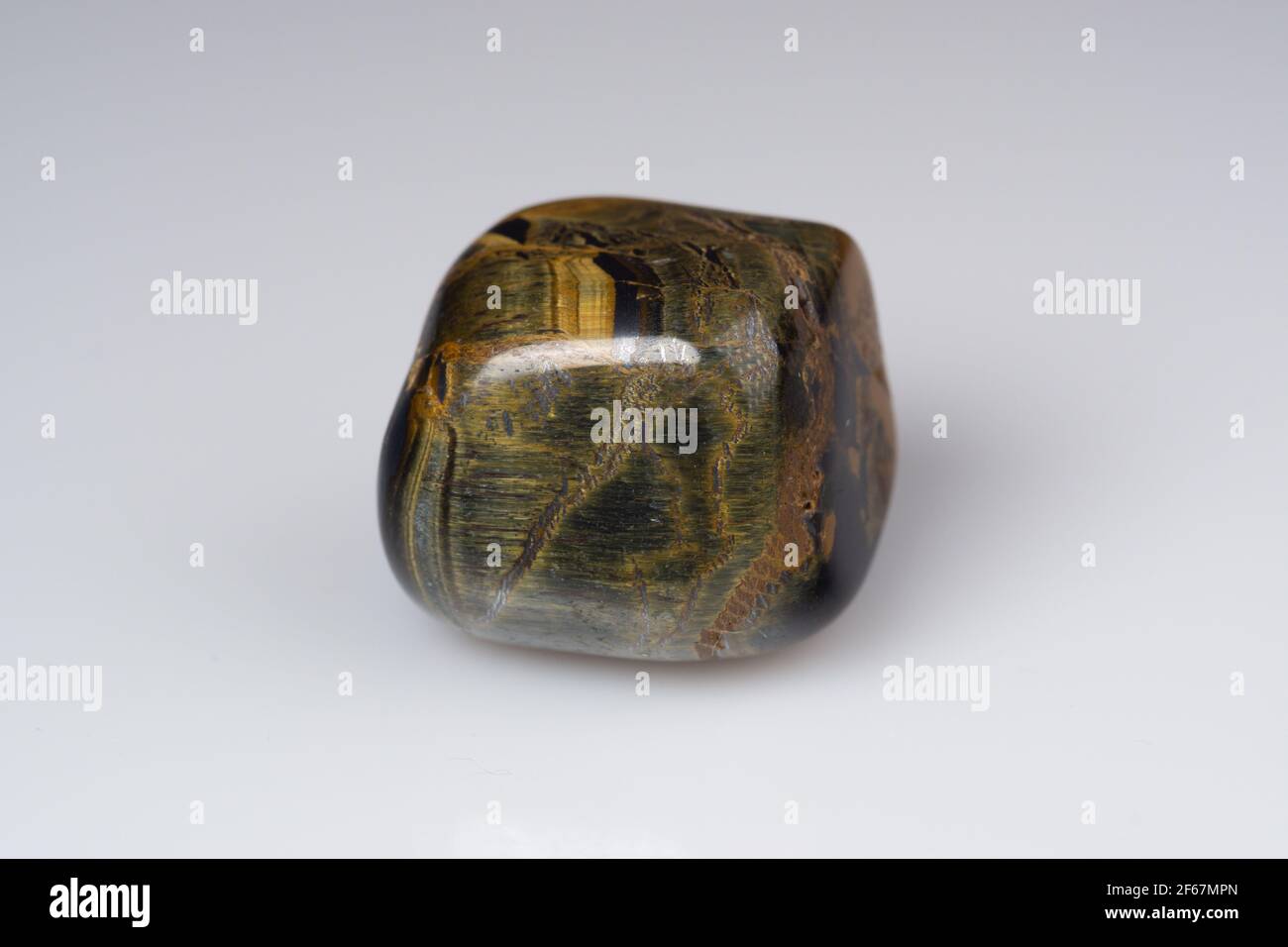 Natural gem tiger's eye on a white background Stock Photo - Alamy